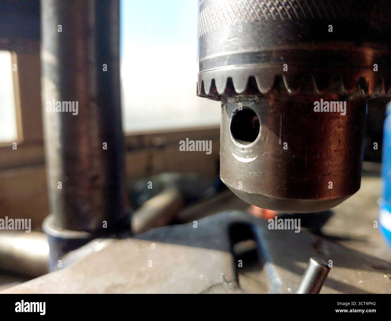 A drilling machine chuck is shown up close while engaged in the ...