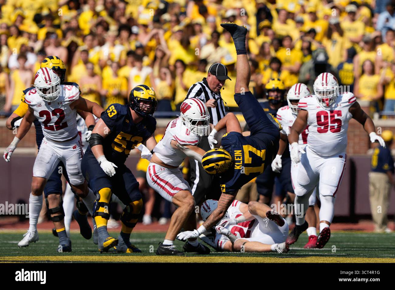 Michigan tight end Marlin Klein (17) is upended as he attempted to ...