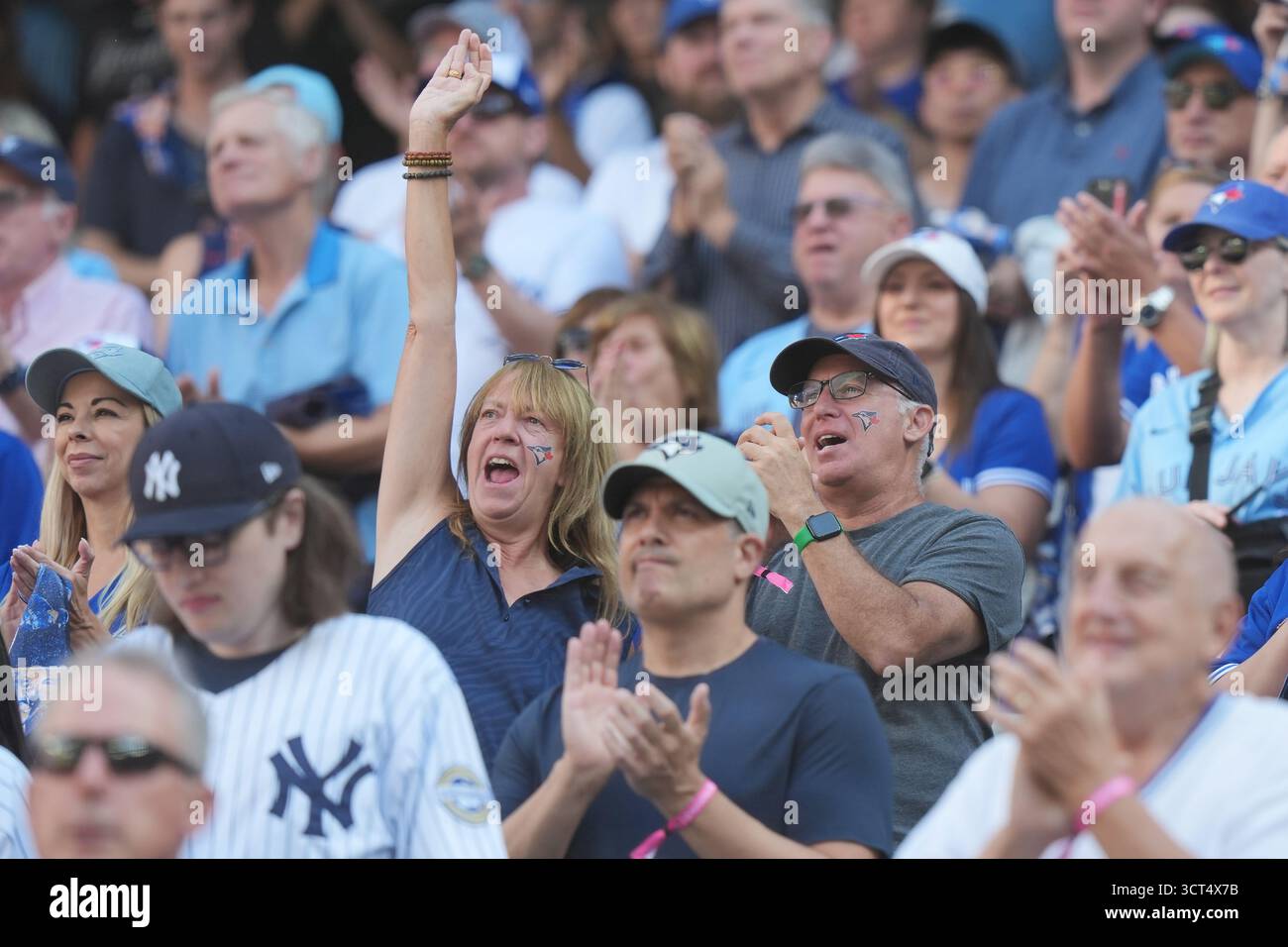 Toronto Blue Jays fans cheer ahead of the start of the American League ...