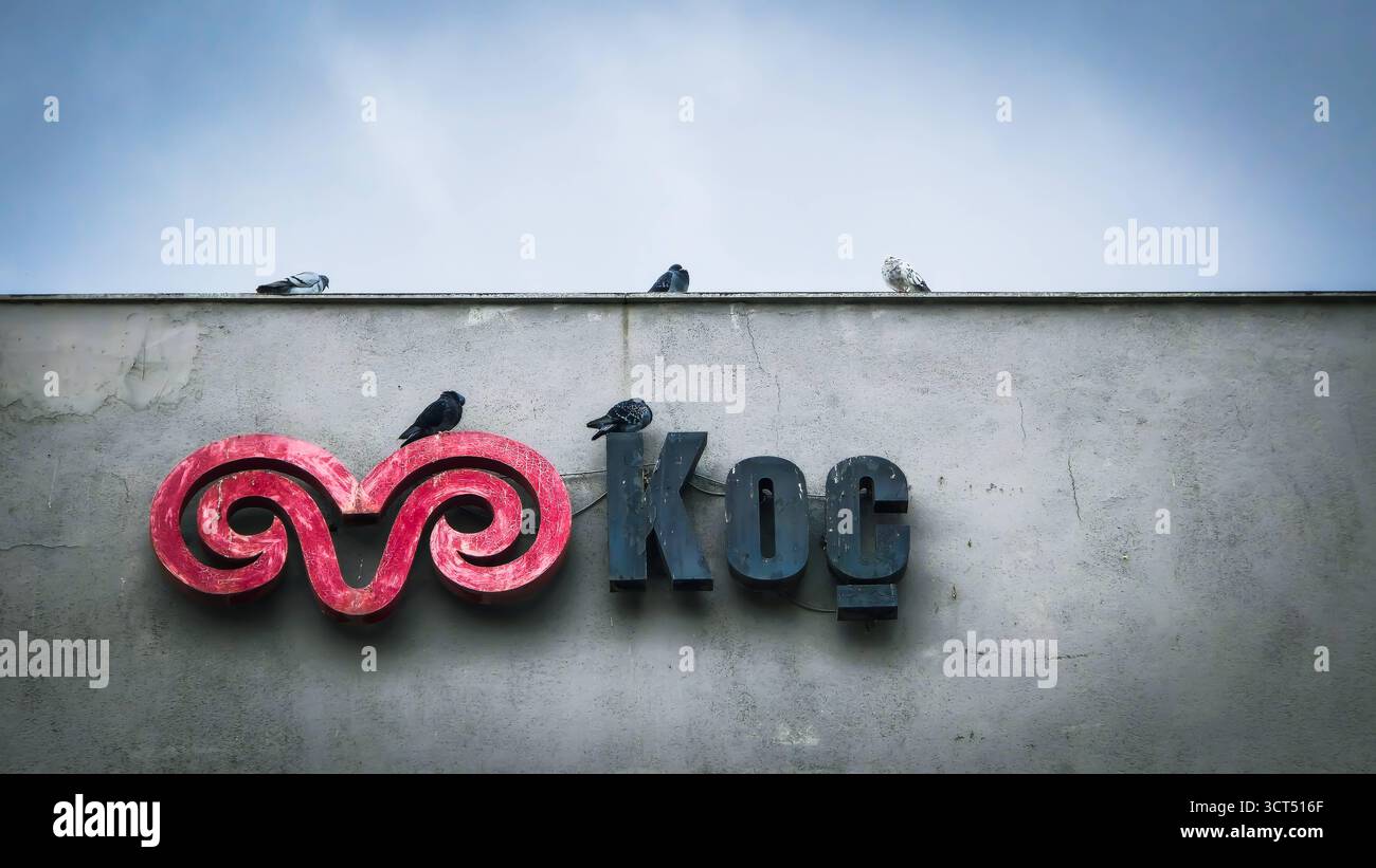 Pigeons sitting on a Koc Holding sign Pigeons sitting on a Koc Holding ...