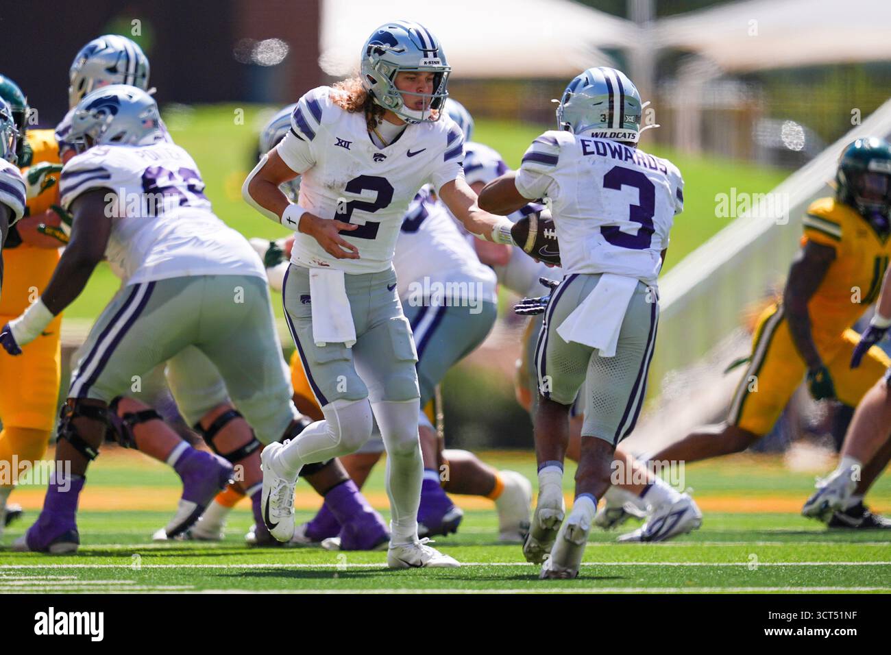 Kansas State quarterback Avery Johnson (2) hands off the ball to Kansas ...
