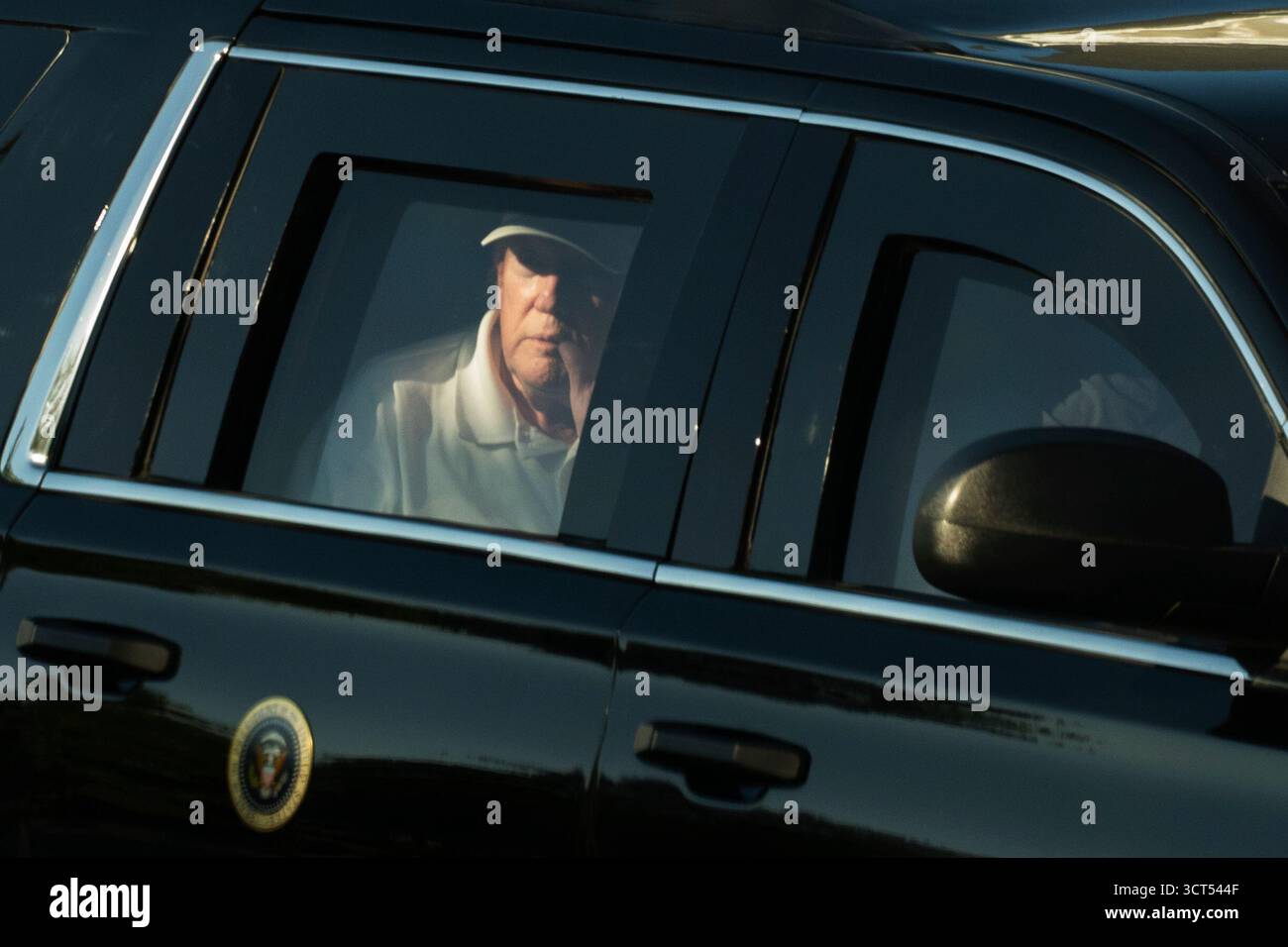 President Donald Trump waves as he leaves Trump National Golf Club in ...