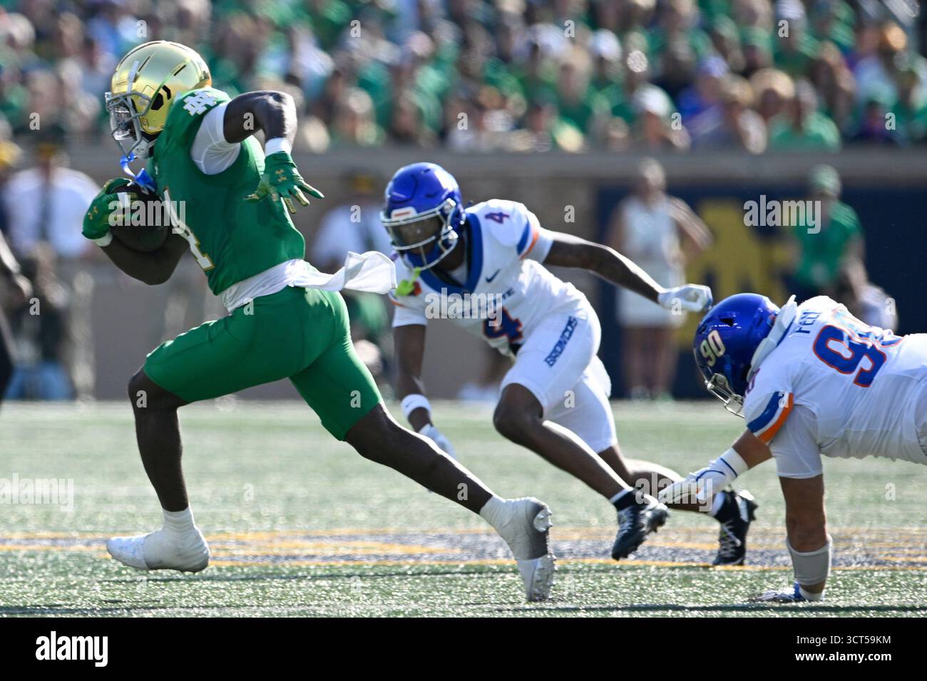 Notre Dame running back Jeremiyah Love (4) rushes against Bosie State's Davon Banks (4) and ...