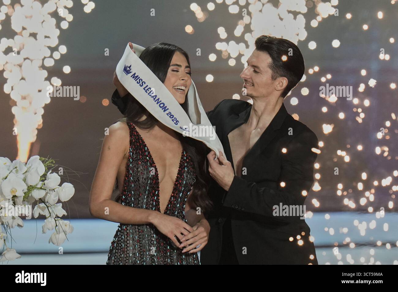 Newly-crowned Miss Lebanon Perla Harb reacts as she receives the winner's sash during the Miss ...