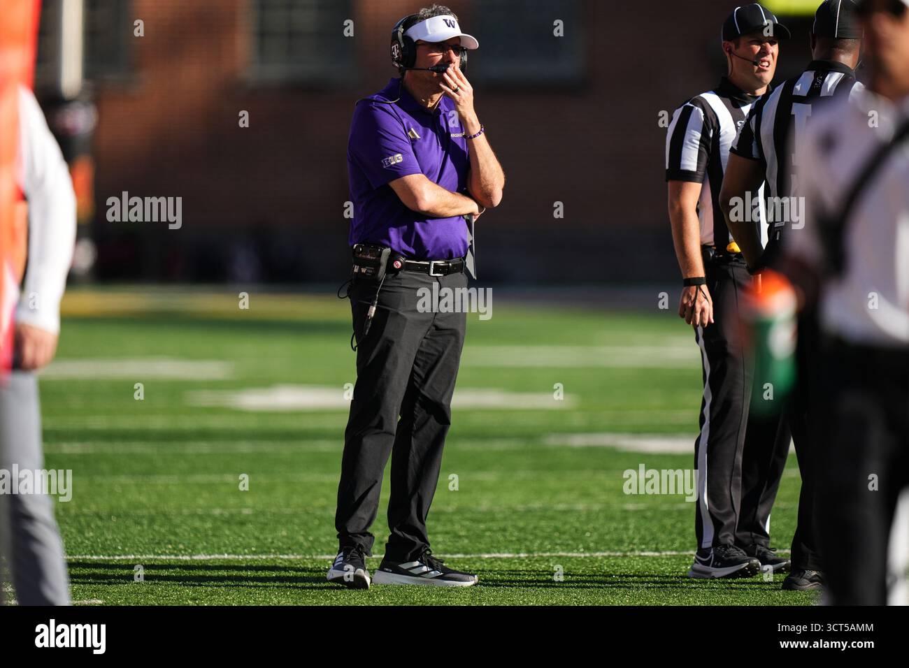 Washington head coach Jedd Fisch, center, watches the first half of an ...