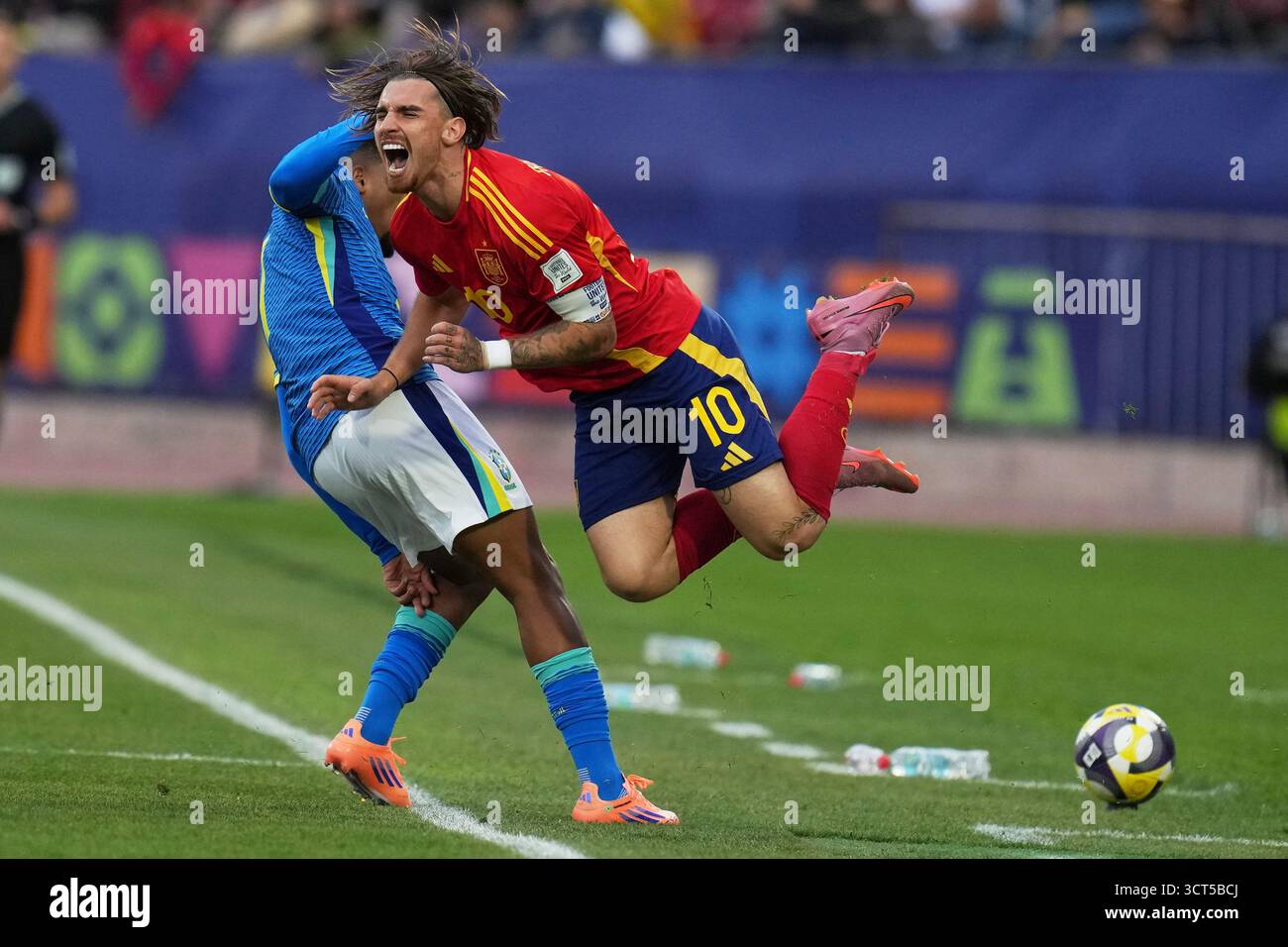 Brazil's Gustavo Prado, left, fouls Spain's Iker Bravo during a FIFA U ...