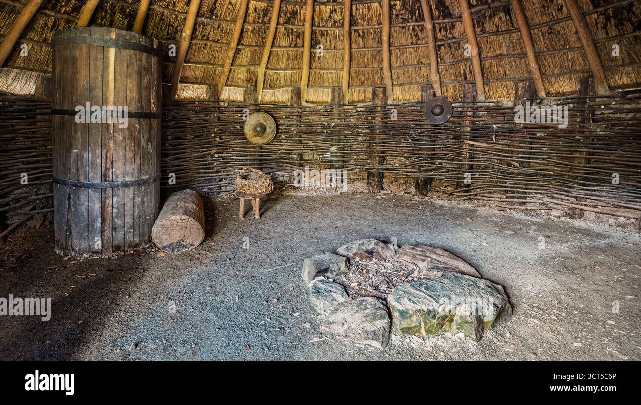 Interior of Viking roundhouse with stone hearth, wattle walls, thatched ...