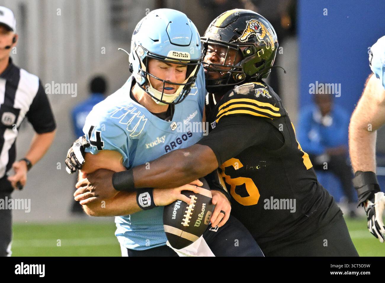 Toronto Argonauts quarterback Nick Arbuckle (4) is sacked by Hamilton ...