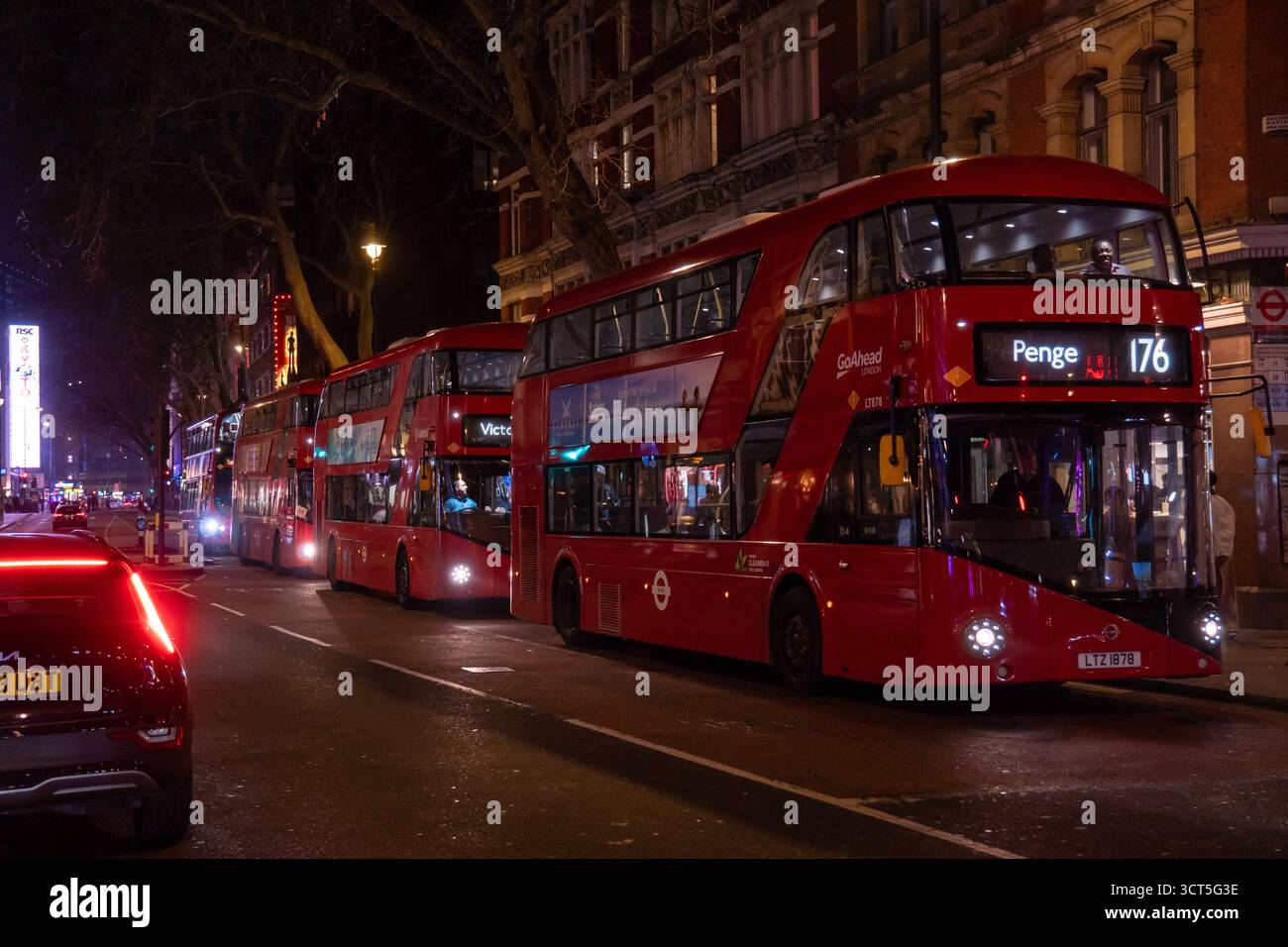 Red Double-Decker Buses on a London Street at Night Stock Photo - Alamy