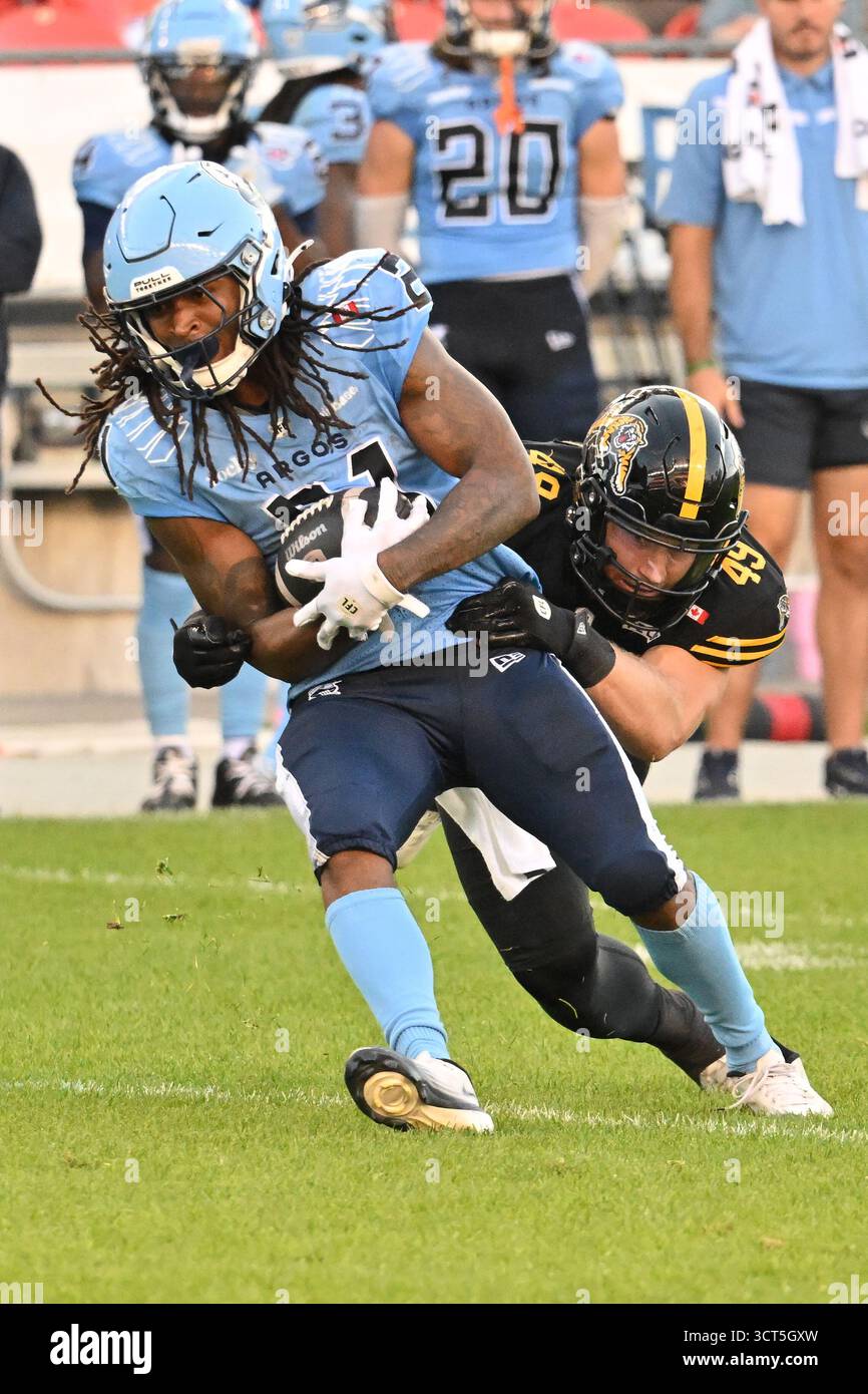 Toronto Argonauts' running back Spencer Brown (21) is tackled by ...