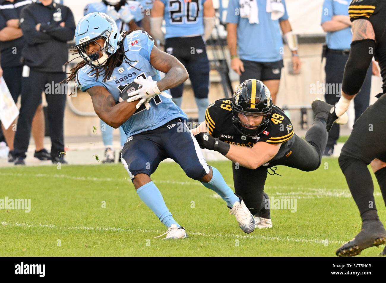 Toronto Argonauts' running back Spencer Brown (21) is tackled by ...
