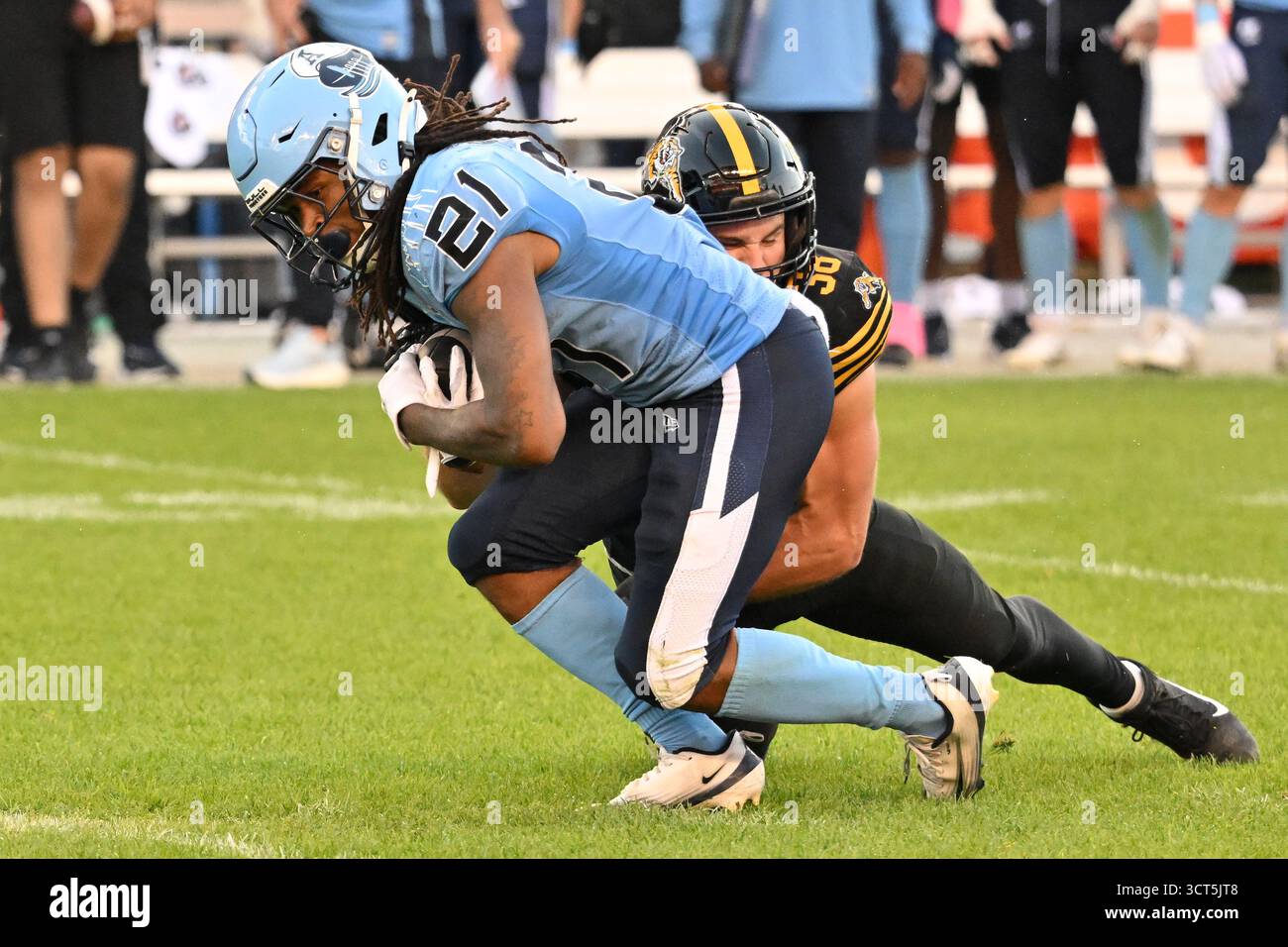 Toronto Argonauts' running back Spencer Brown (21) is tackled by ...