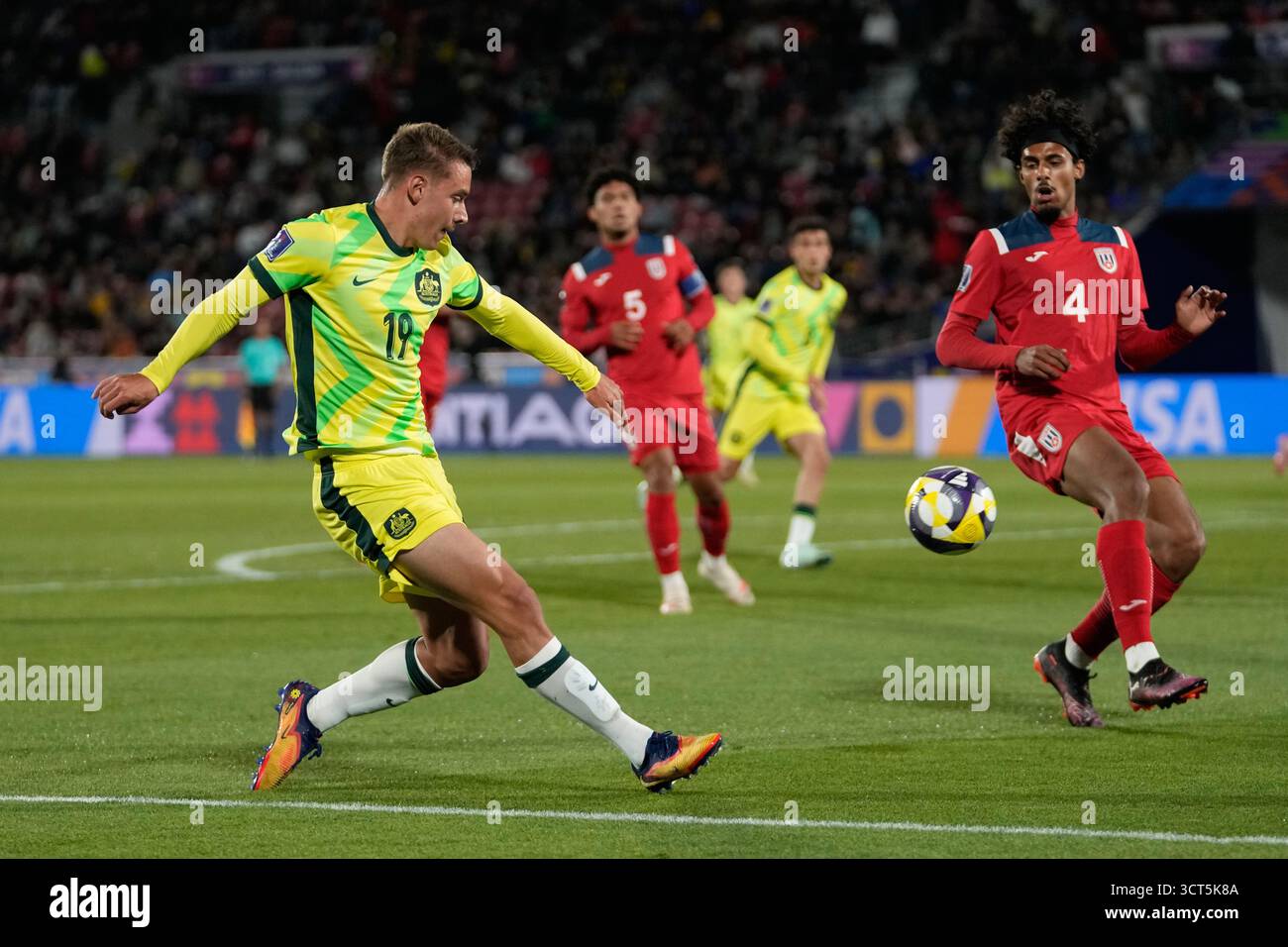 Australia's Max Caputo, left, scores his side's opening goal against ...