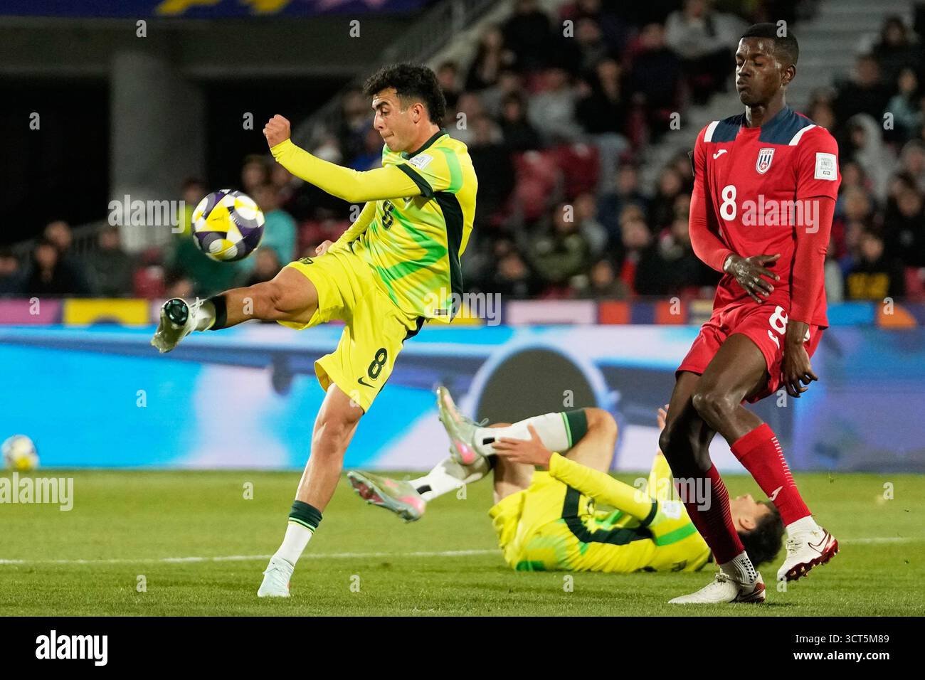 Australia's Alexander Badolato, left, attempts a shot on goal past Cuba ...
