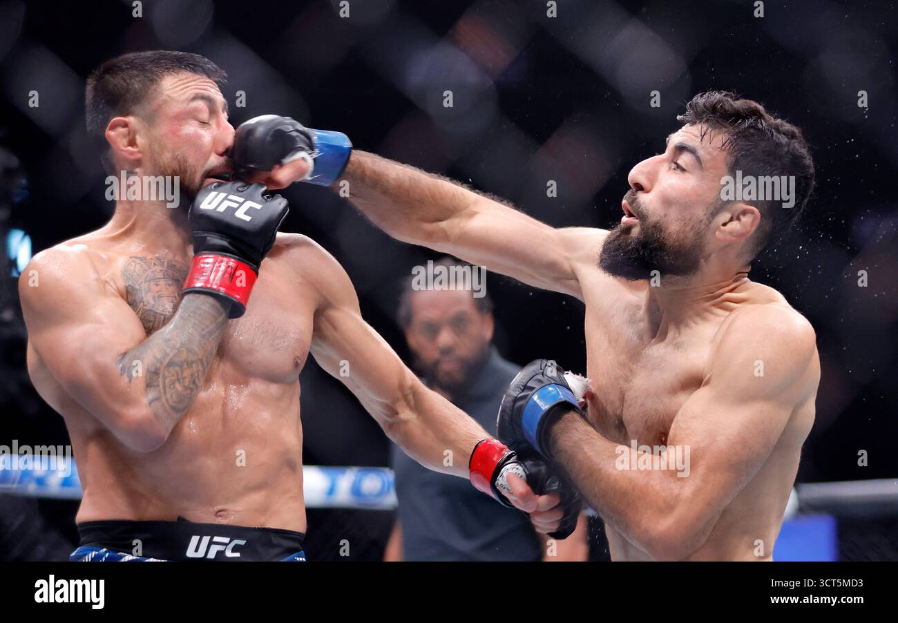 UFC bantamweight fighter Farid Basharat, right, punches Chris Gutierrez ...