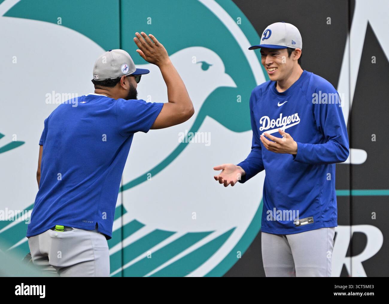 Los Angeles Dodgers pitcher Roki Sasaki smiles during a training ...