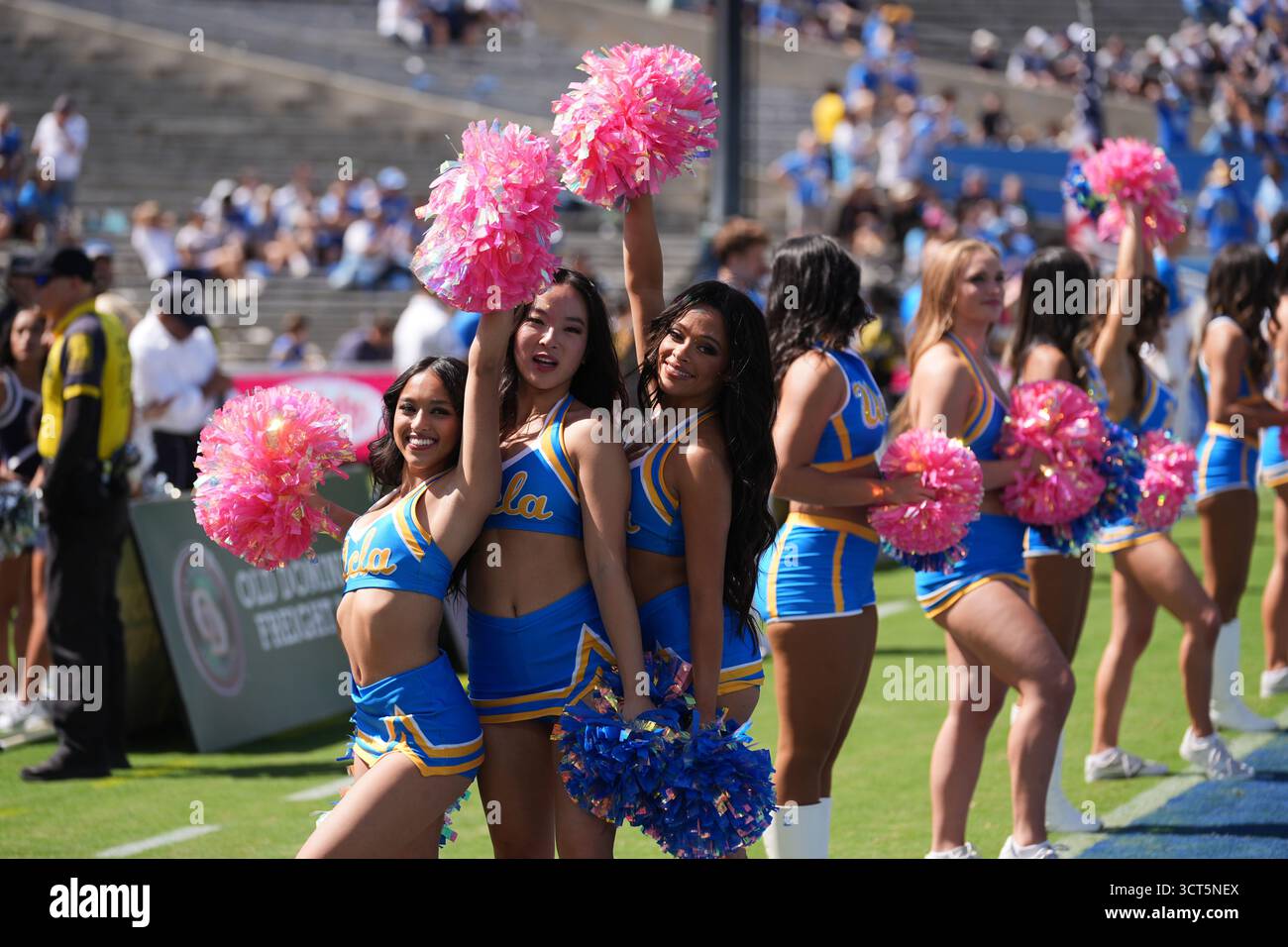 UCLA cheerleaders perform during an NCAA college football game against ...
