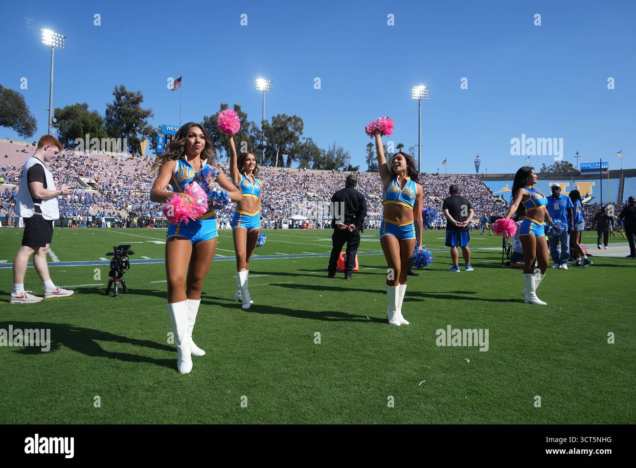 UCLA cheerleaders perform during an NCAA college football game against ...