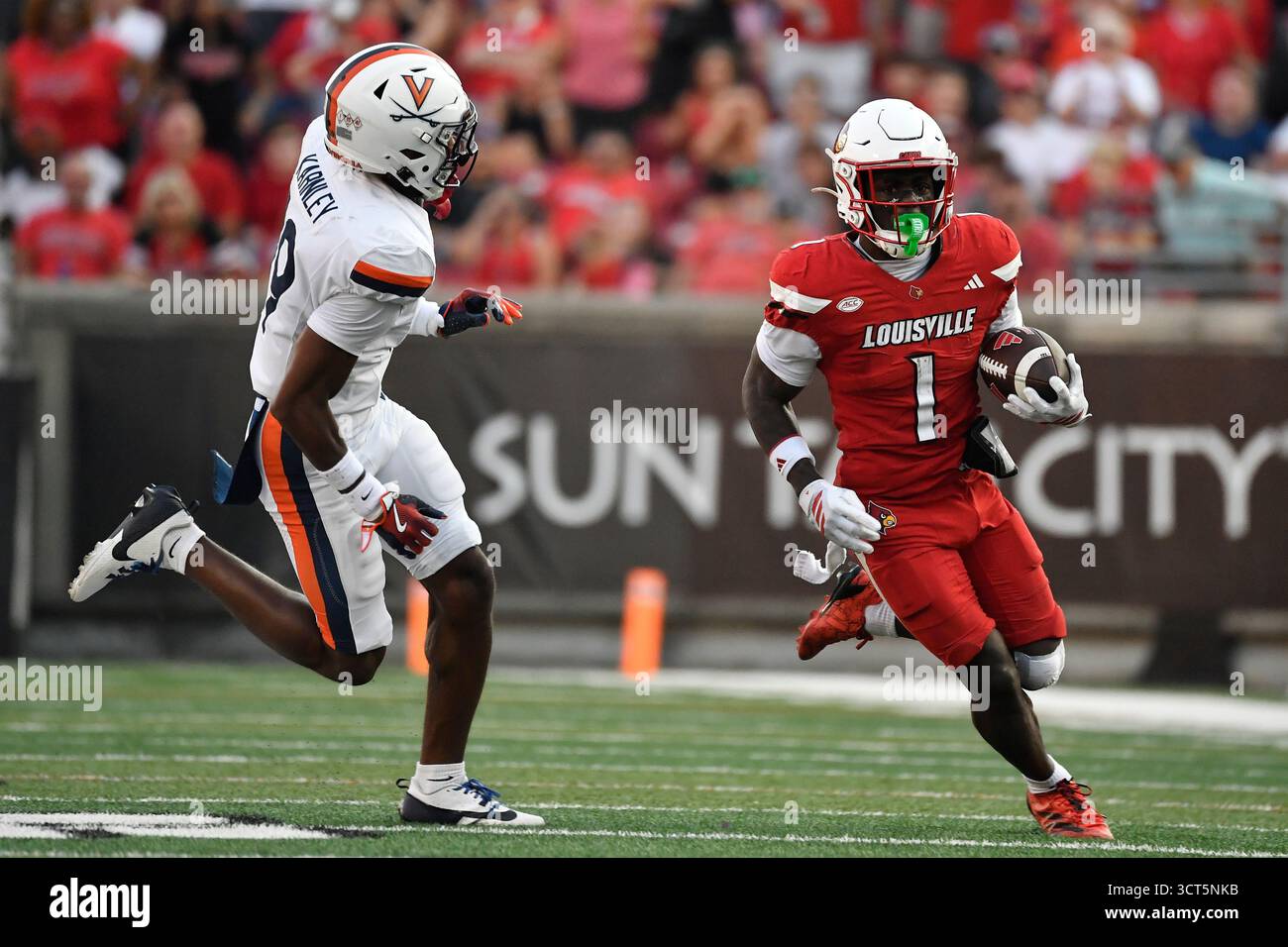 Louisville Cardinals running back Isaac Brown (1) is pursued by ...