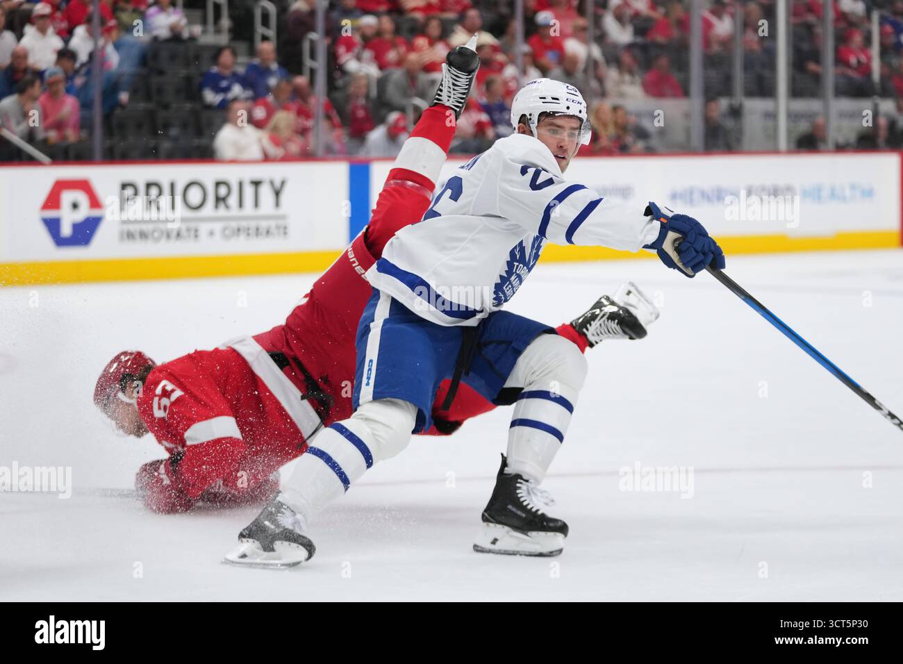 Toronto Maple Leafs' Jacob Quillan (26) checks Detroit Red Wings defenseman Moritz Seider (53 ...