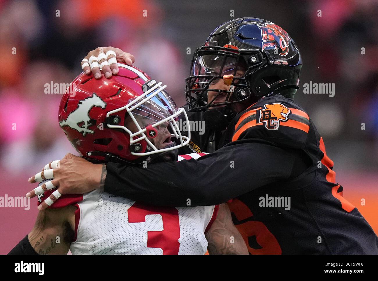 Calgary Stampeders quarterback Vernon Adams Jr., left, is hit by B.C ...