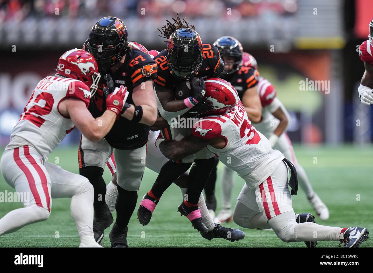 B.C. Lions' James Butler (20) is stopped by Calgary Stampeders' Kyle ...