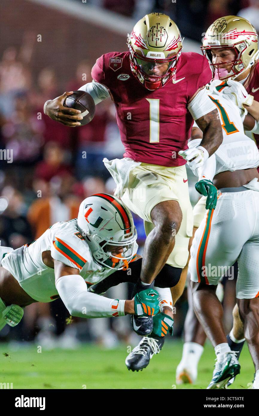 Florida State quarterback Tommy Castellanos (1) tries to jump by Miami ...