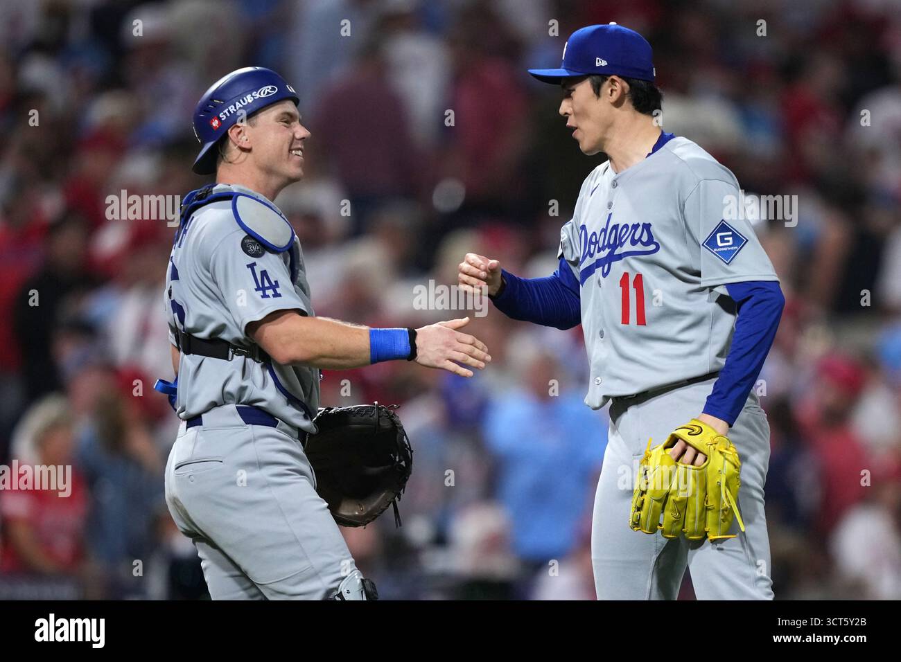 Los Angeles Dodgers' Will Smith, left, and Roki Sasaki celebrate after ...