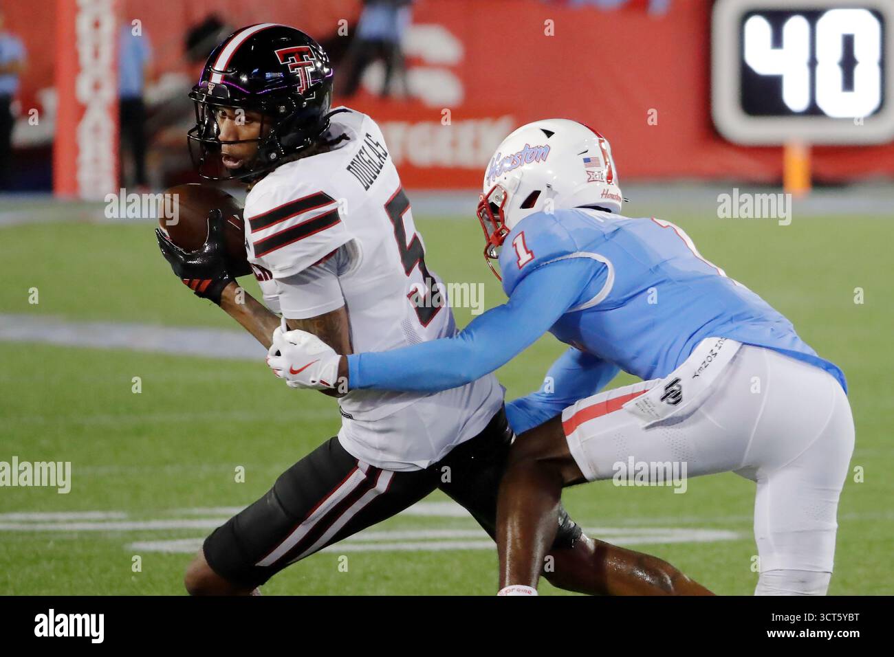 Texas Tech wide receiver Caleb Douglas (5) breaks the tackle attempt by ...