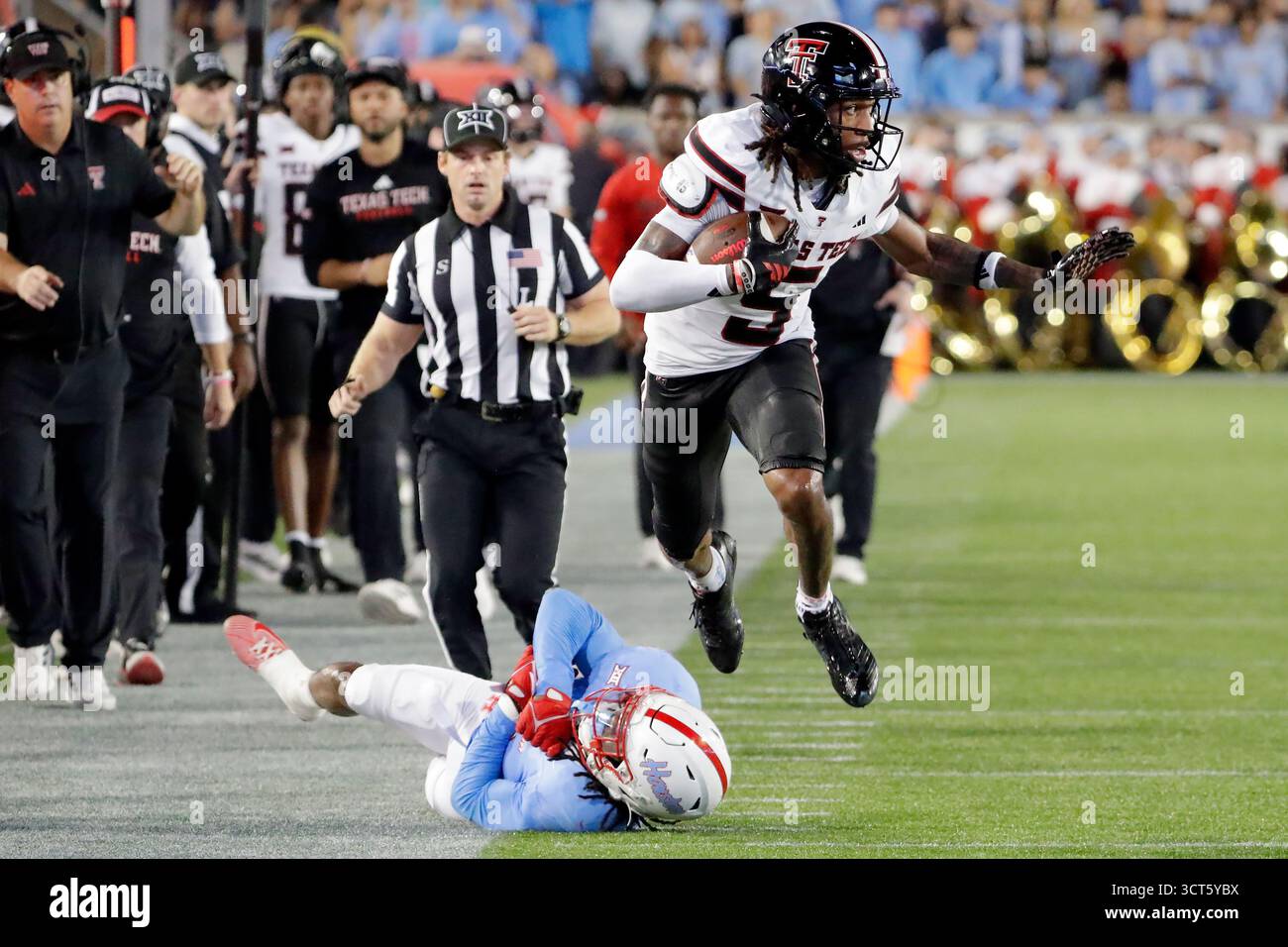 Texas Tech wide receiver Caleb Douglas (5) jumps over the tackle ...