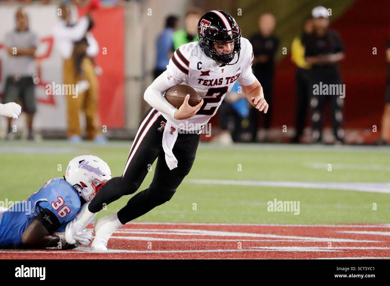 Texas Tech quarterback Behren Morton (2) is tripped up by Houston ...