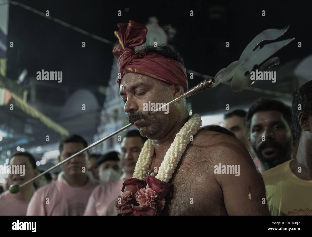 Bangkok, Thailand - 02 Oct, 2025 - a devotee participating in a ritual ...