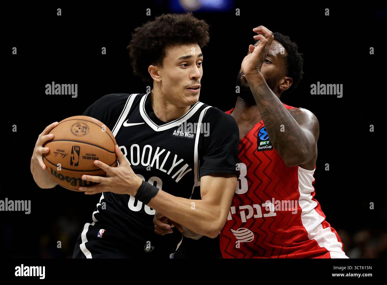 Brooklyn Nets guard Nolan Traore, left, drives past Hapoel Jerusalem ...