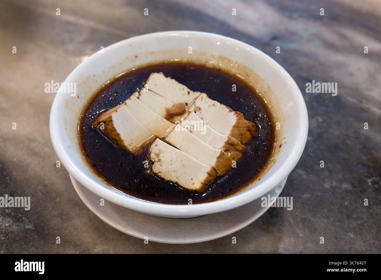 Serving of tofu in gravy, is simple and popular teochew porridge dish ...