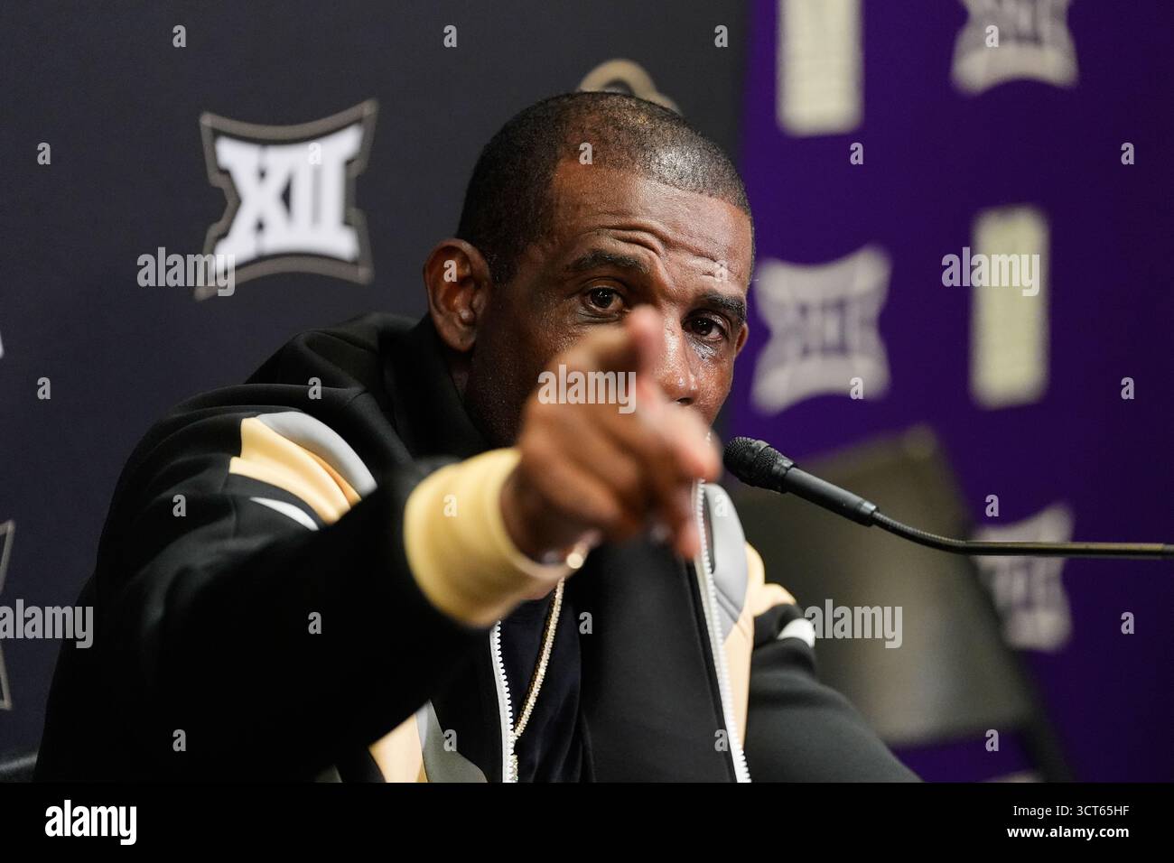 Colorado head coach Deion Sanders points as he responds to a question ...