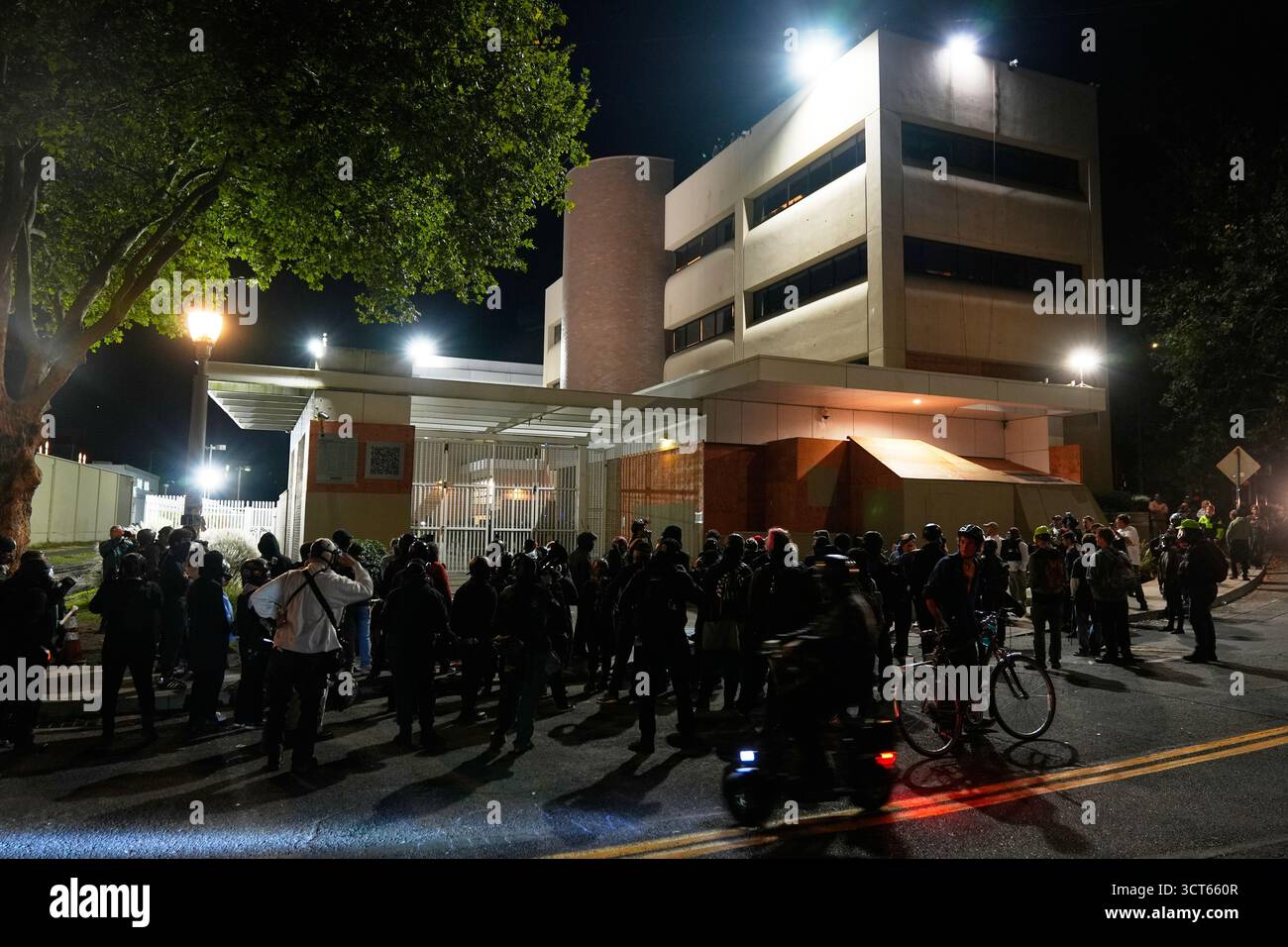 Demonstrators stand outside a U.S. Immigration and Customs Enforcement ...