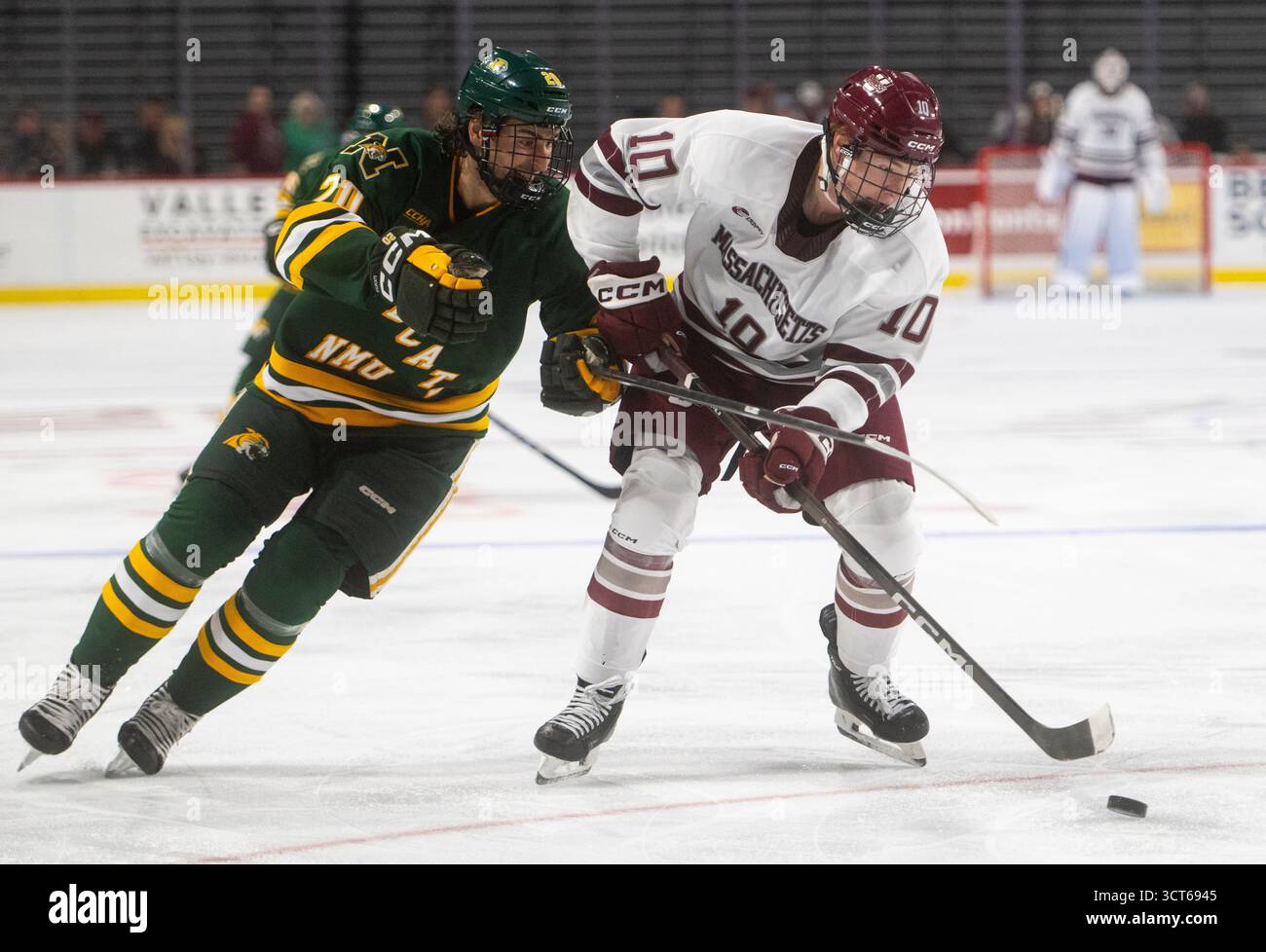 Northern Michigan defenseman Anthony Cliche (20) and UMass forward Jack ...