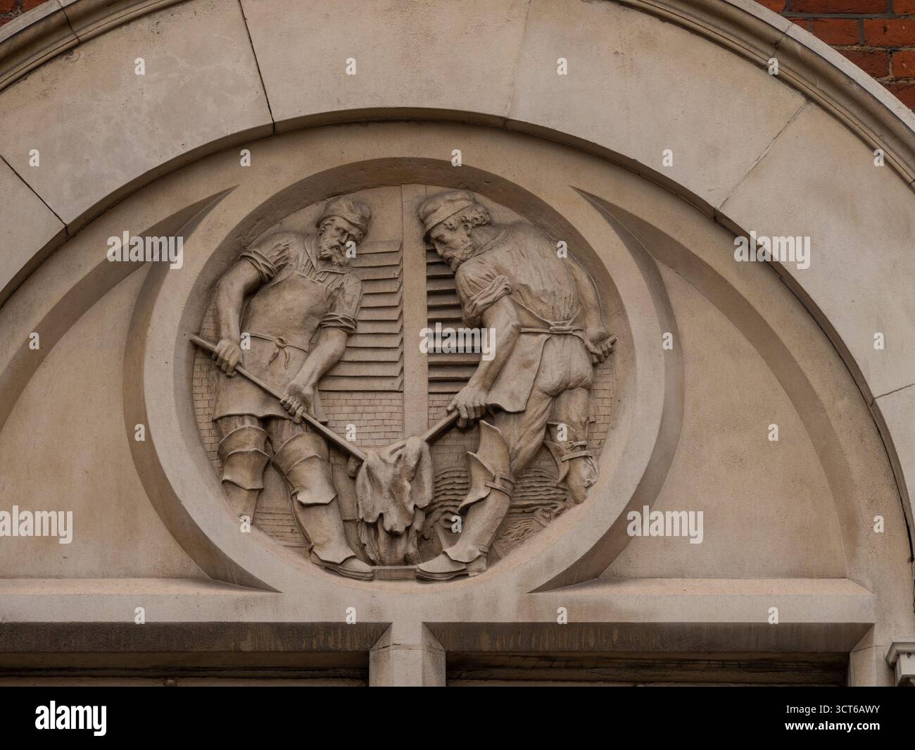 LONDON, UK - AUGUST 17, 2018: Carved mural of workmen on the exterior ...