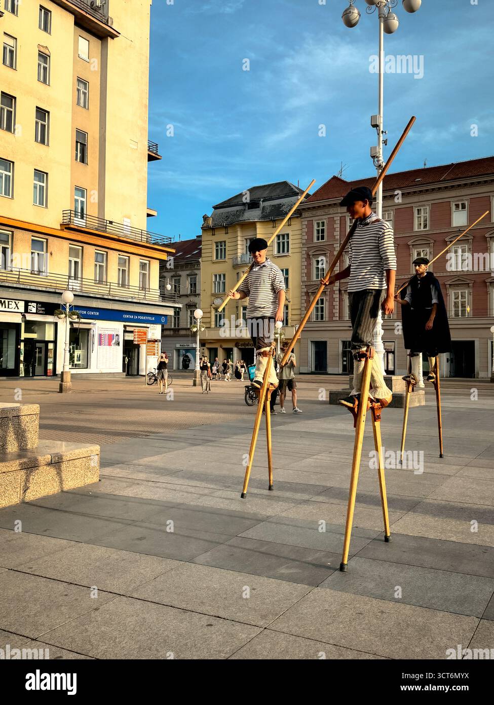 Performers in traditional Croatian folk costumes walk on stilts around ...