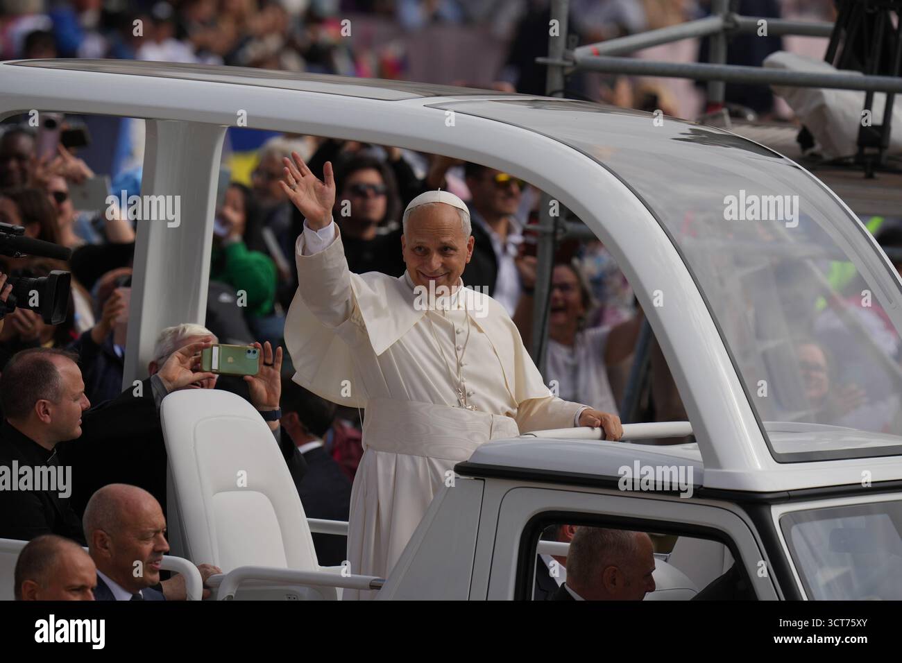 Pope Leo XIV waves from his popemobile at the end of a Mass for the ...