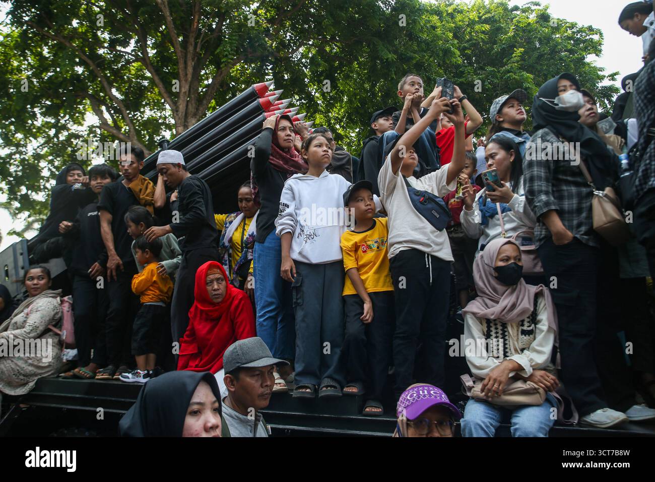 Residents watch the 80th Anniversary Parade of the Indonesian National ...