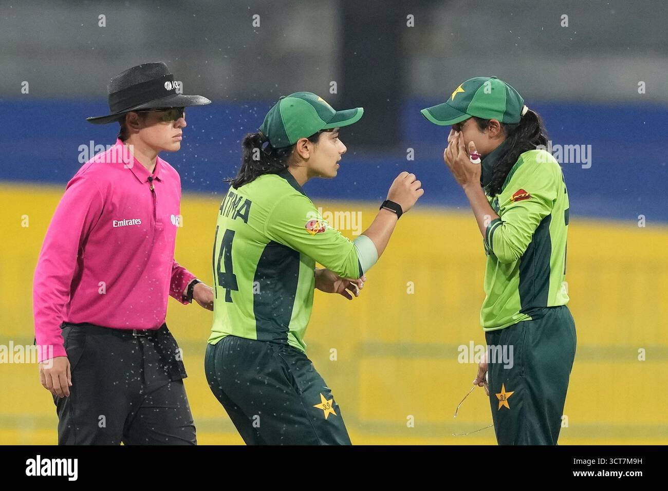 Pakistan's captain Fatima Sana helps Rameen Shamim remove a bug stuck in her eye during the ...
