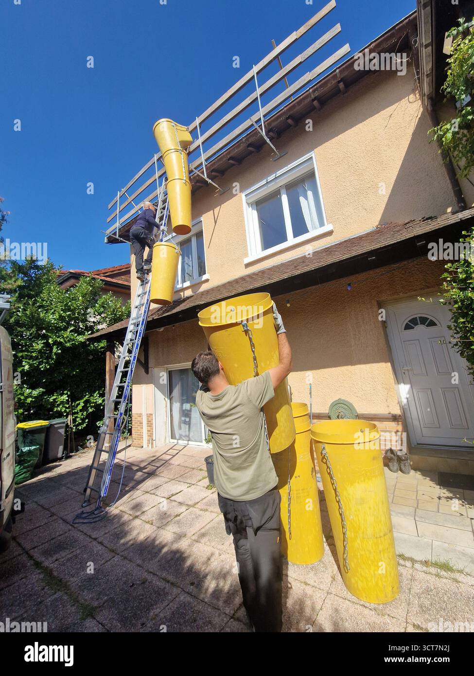 Rubble evacuation hopper, repairing a roof, Renovation works on a ...