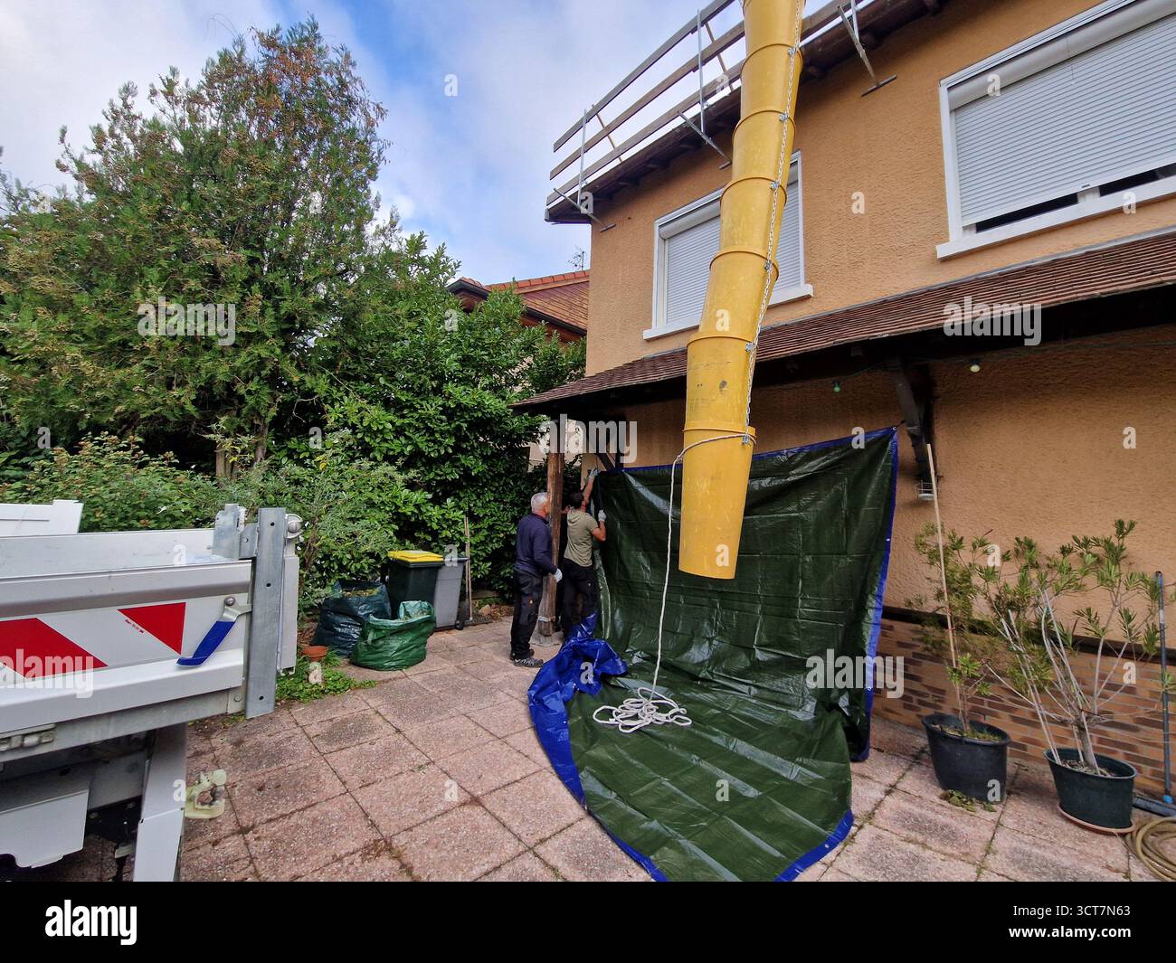Rubble evacuation hopper, repairing a roof, Renovation works on a ...