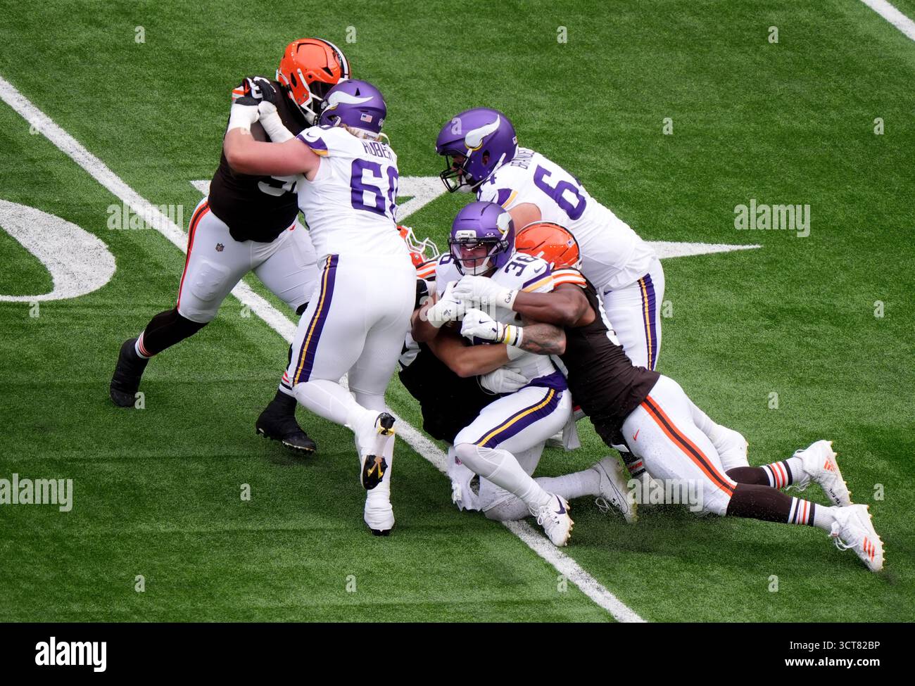 Minnesota Vikings' Zavier Scott is tackled by Cleveland Browns' Myles ...
