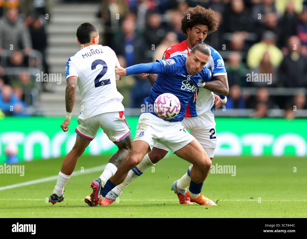 Everton's Jack Grealish (centre) battles for the ball with Crystal ...