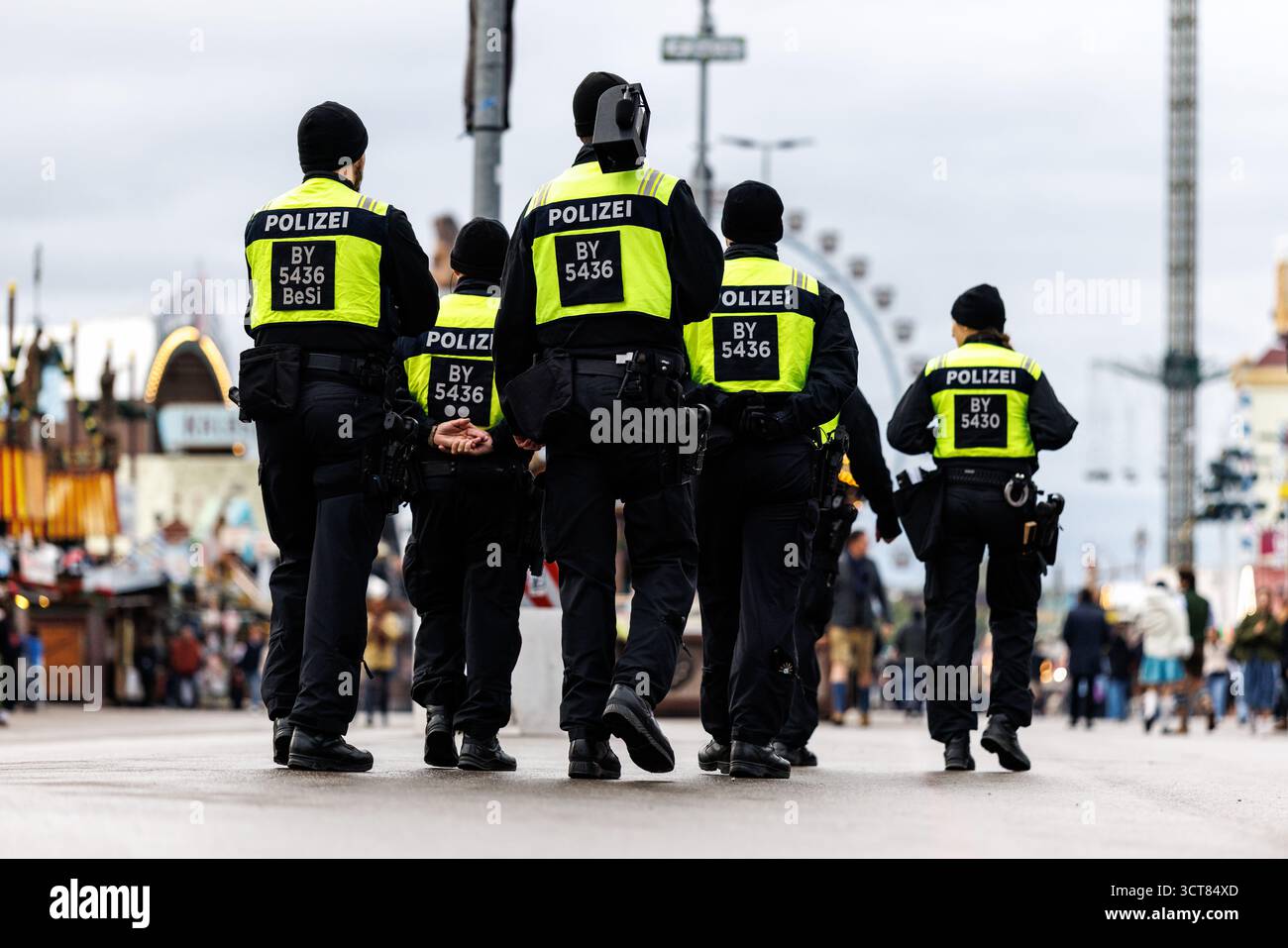 05 October 2025, Bavaria, Munich: Police officers walk in a group ...