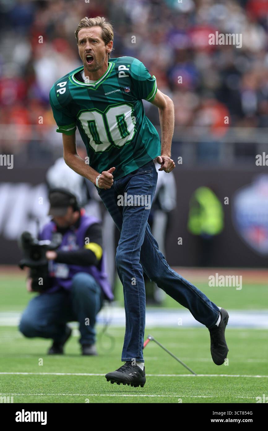 Former England soccer player Peter Crouch attempts a field goal at the ...