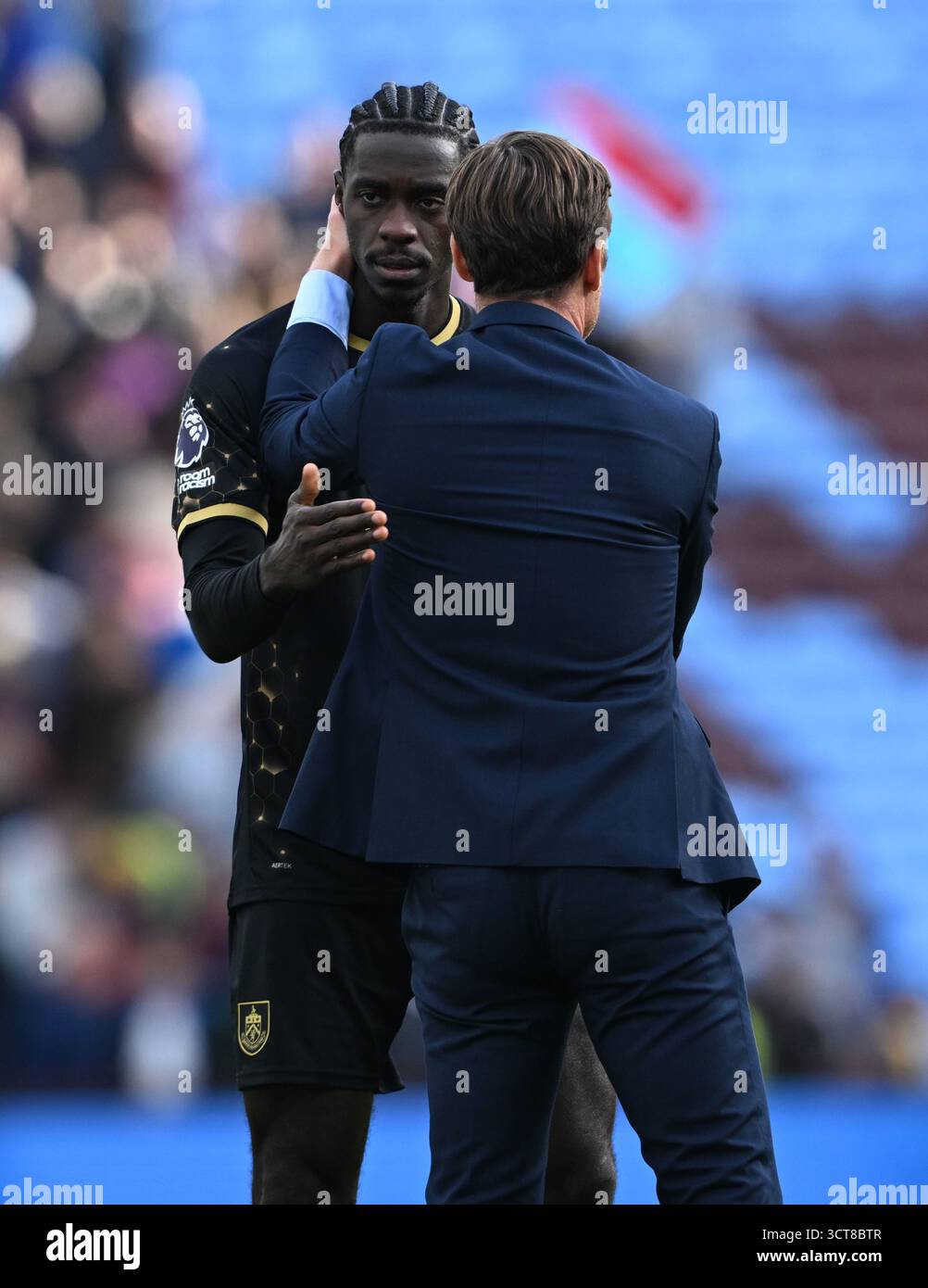 Burnley manager Scott Parker (right) and after the Premier League match ...