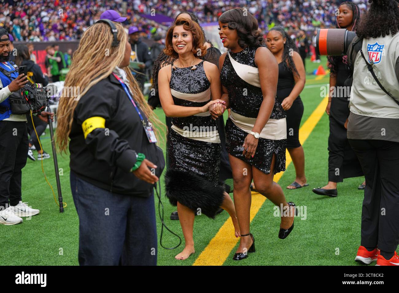 Singer, Raye, center left, leaves after performing at half-time during ...